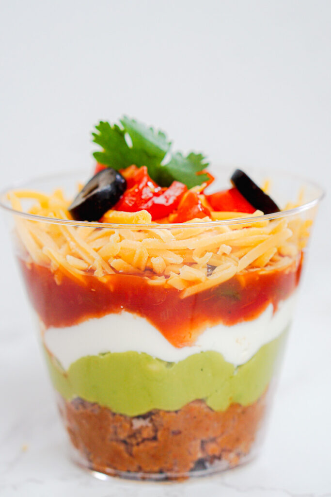 Individual 7 Layer Dip Cups - A Perfect Party Appetizer | She's Not Cookin'